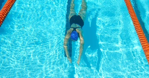 Female swimmer swimming inside the pool ... | Stock Video | Pond5