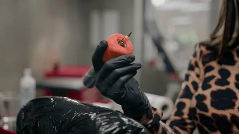 Female tattoo artist holding a washing t... | Stock Video | Pond5