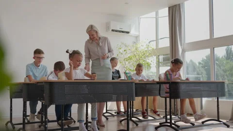 Female teacher controlling learning proc... | Stock Video | Pond5