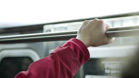 Female train rider holding rail on subwa... | Stock Video | Pond5