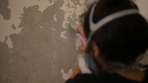 Female Worker Scratching Wall and Remove... | Stock Video | Pond5