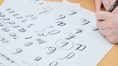 Female writing letters in copy sheet wit... | Stock Video | Pond5