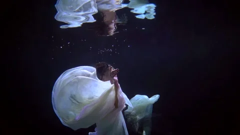 feminine graceful lady is floating under... | Stock Video | Pond5