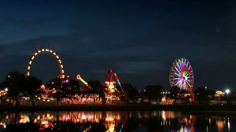 Ferris wheel and carnival rides at dusk | Stock Video | Pond5