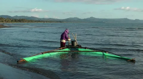 Filipino woman catching Milkfish fry in ... | Stock Video | Pond5