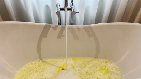 Fill a bathtub with yellow Bubble Bath B... | Stock Video | Pond5