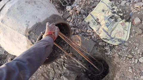 Filling the pile head with a hand tool. | Stock Video | Pond5