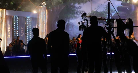 Film Crew silhouettes at stage Night tim... | Stock Video | Pond5