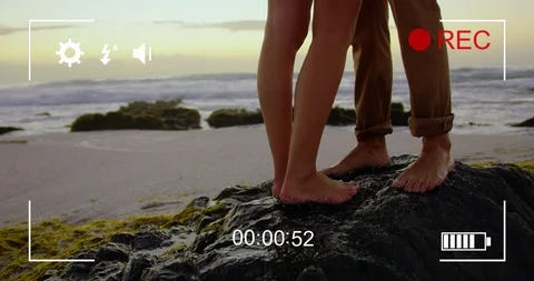 Filming a couple on a beach on a digital... | Stock Video | Pond5