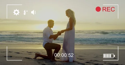 Filming a couple on a beach on a digital... | Stock Video | Pond5