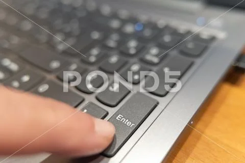 Finger pressing the enter key on a computer, macro photo. Stock Image ...
