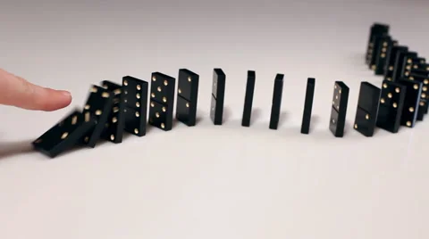 Finger pushing dominoes in a row causing... | Stock Video | Pond5