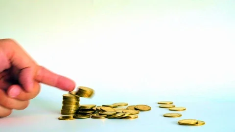 Finger pushing a pile of gold coins or c... | Stock Video | Pond5