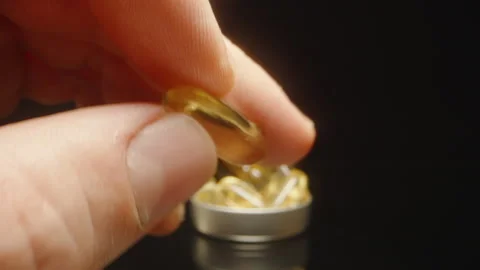 Fingers Squeezing an Omega 3 Capsule to ... | Stock Video | Pond5