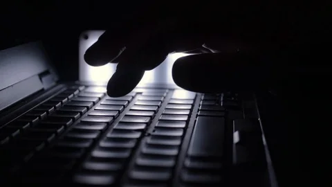 Fingers typing on keyboard in dark room | Stock Video | Pond5