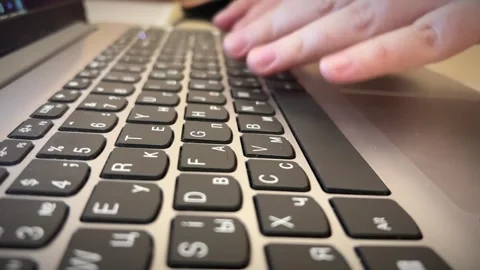 Fingers typing on a laptop keyboard with... | Stock Video | Pond5