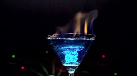 Fire blowing out of blue lagoon glass | Stock Video | Pond5