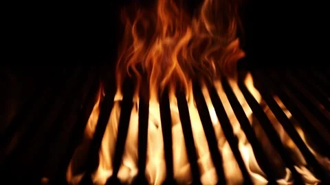 The fire burns through the grill grate. ... | Stock Video | Pond5