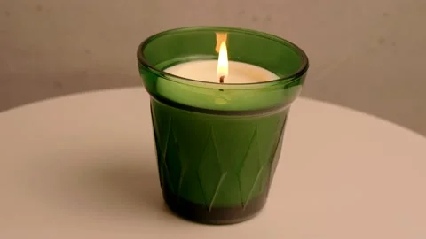Fire candle in a green glass candlestick... | Stock Video | Pond5