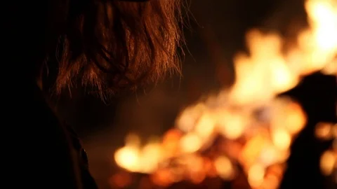 Fire creates creepy lighting on girl's f... | Stock Video | Pond5