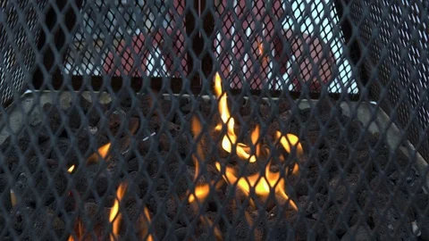 Fire flames enclosed in safety grate | Stock Video | Pond5