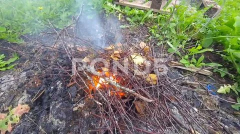 The fire is ignited in a fire of twigs and branches ~ Hi Res #98643803