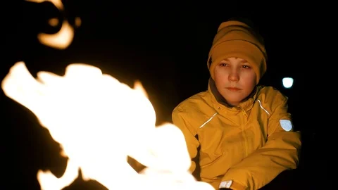The fire illuminates the face of the boy... | Stock Video | Pond5