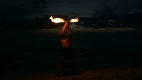 Fire juggler juggling fire sticks in the... | Stock Video | Pond5