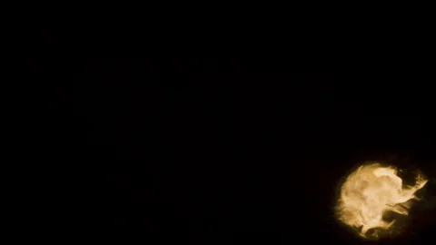 Fireball floating in front of a black ba... | Stock Video | Pond5