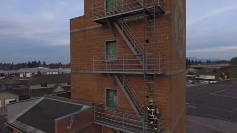 Firefighter Climbing a Building's Fire E... | Stock Video | Pond5
