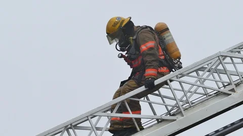 Firefighter descending ladder | Stock Video | Pond5