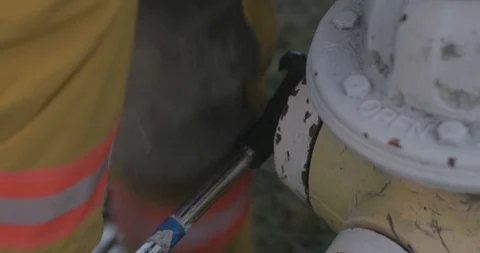 Firefighter removes fire hydrant cap | Stock Video | Pond5