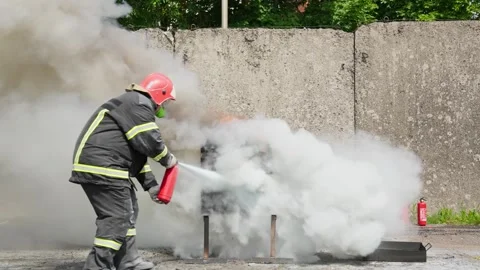 Firefighter using fire extinguisher to p... | Stock Video | Pond5