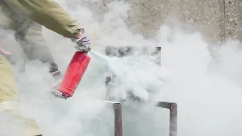 Firefighter using fire extinguisher to p... | Stock Video | Pond5