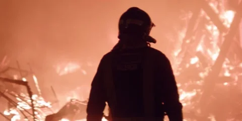 Firefighter walking towards flame of gia... | Stock Video | Pond5