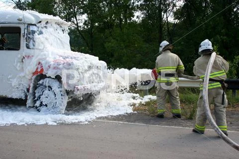 Firefighters extinguish a fire in a burning bus Stock Image #31411576