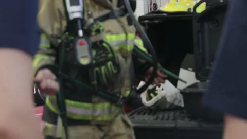 Firefighters trying on and explaining fi... | Stock Video | Pond5