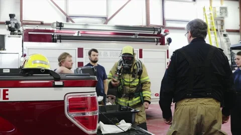 Firefighters trying on fire protection s... | Stock Video | Pond5