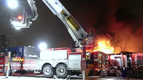Firefighters using an aerial ladder to c... | Stock Video | Pond5