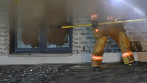 Fireman breaking window at the beginning... | Stock Video | Pond5