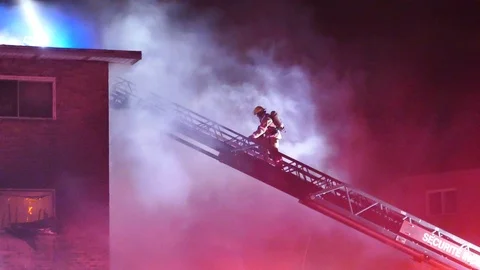 Fireman climbing ladder structure fire | Stock Video | Pond5