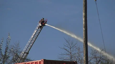 Fireman fighting fire spraying water fro... | Stock Video | Pond5
