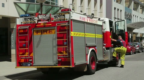 fireman gets into fire engine with flash... | Stock Video | Pond5
