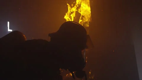 Fireman with Oxygen Tank Standing Amidst... | Stock Video | Pond5