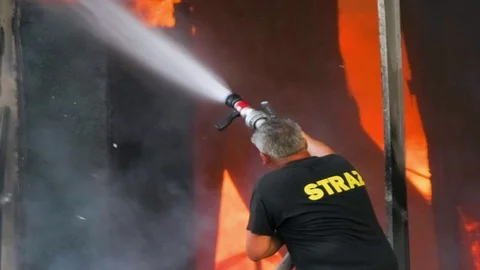 Fireman tries to put out house fire cine... | Stock Video | Pond5