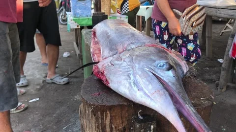 fish butcher is cutting the head of a hu... | Stock Video | Pond5