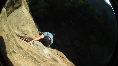 Fish-eye shot of a rock climber climbing... | Stock Video | Pond5