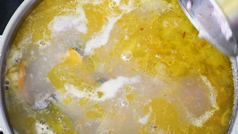 Fish soup boiling in a metal pot on a bl... | Stock Video | Pond5