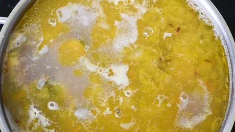 Fish soup boiling in a metal pot on a bl... | Stock Video | Pond5