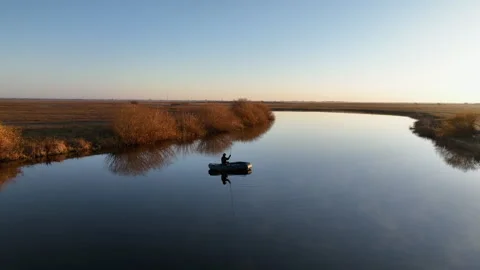 Fisherman cast the line from the boat on... | Stock Video | Pond5